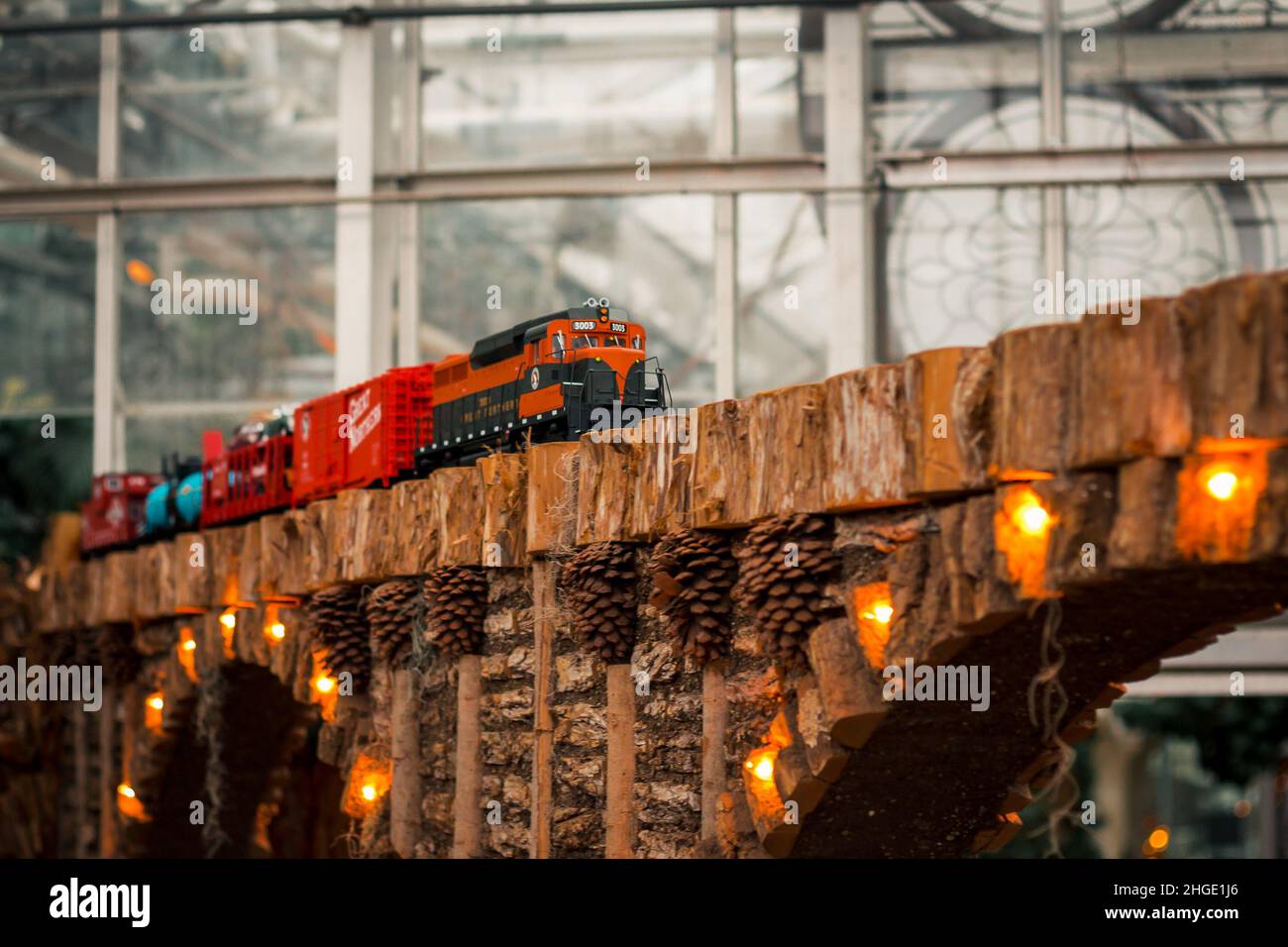 Model Locomotive train crossing a bridge in a holiday train display ...
