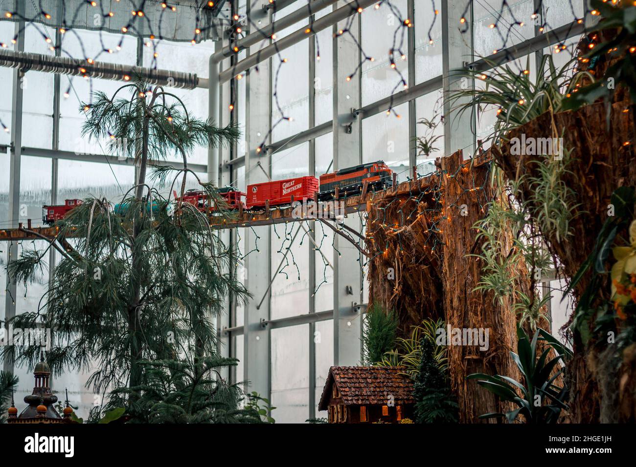 Model locomotive train on a bridge in a greenhouse Stock Photo - Alamy