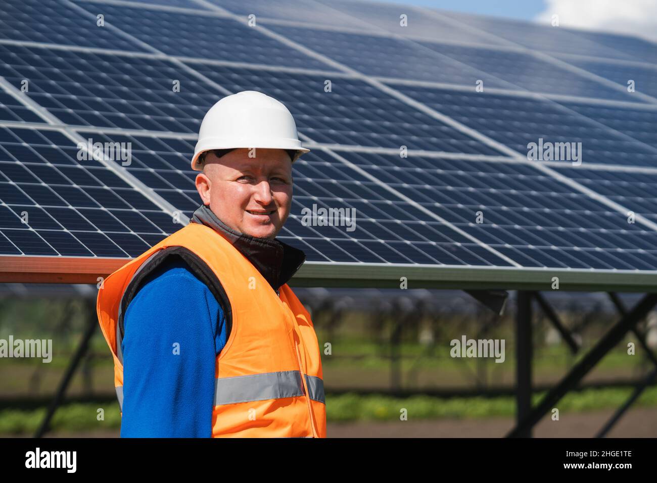 Portrait of male electrical engineer on the background of solar panels ...