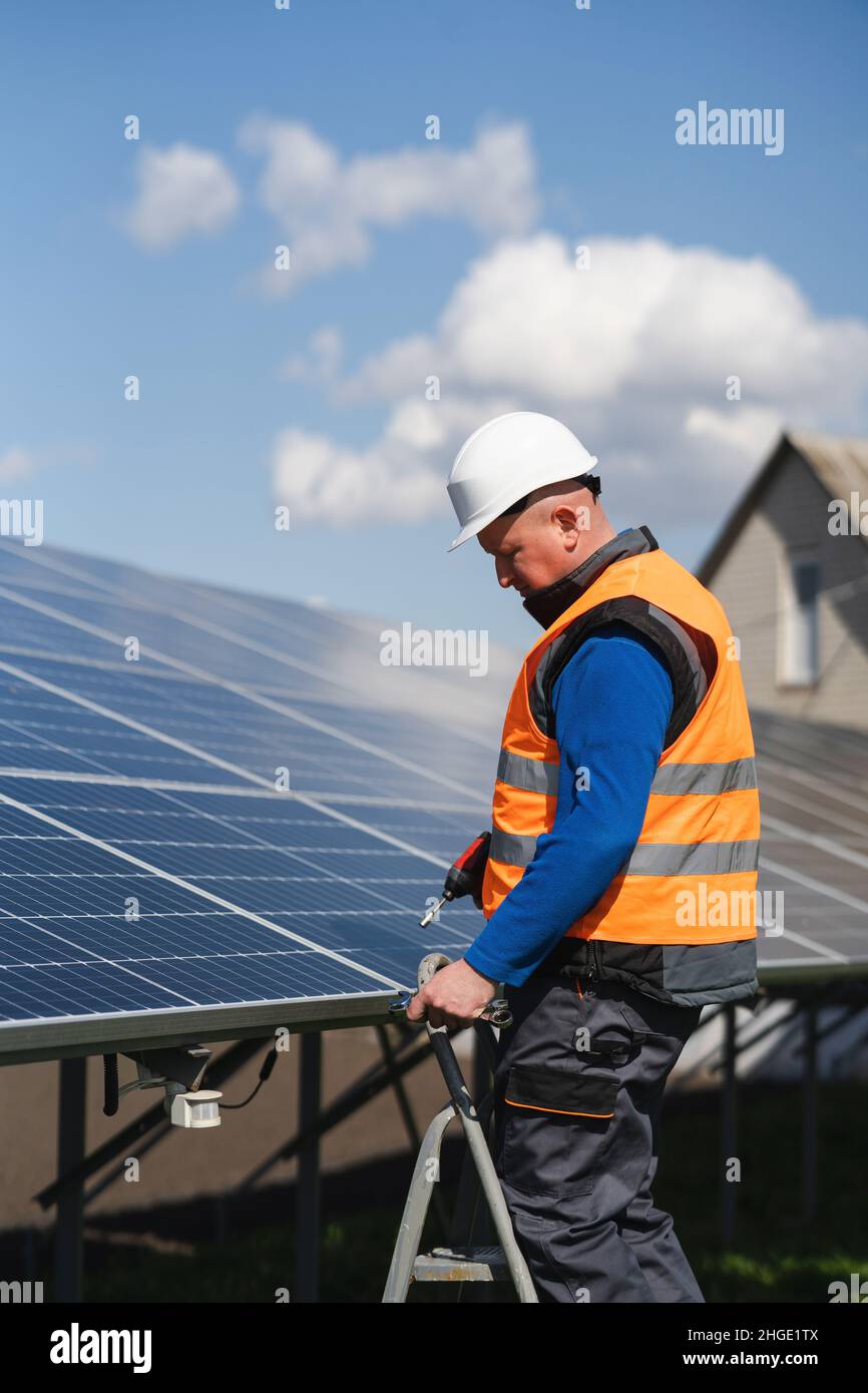 Solar panel assembler stands on a ladder Stock Photo - Alamy