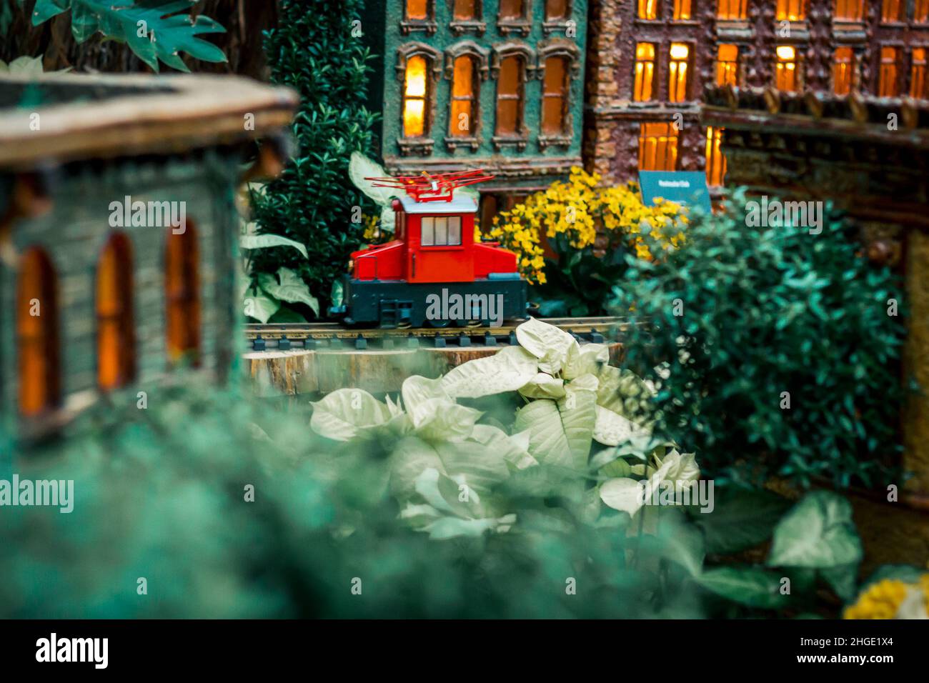 Red Model train running through a city Stock Photo - Alamy