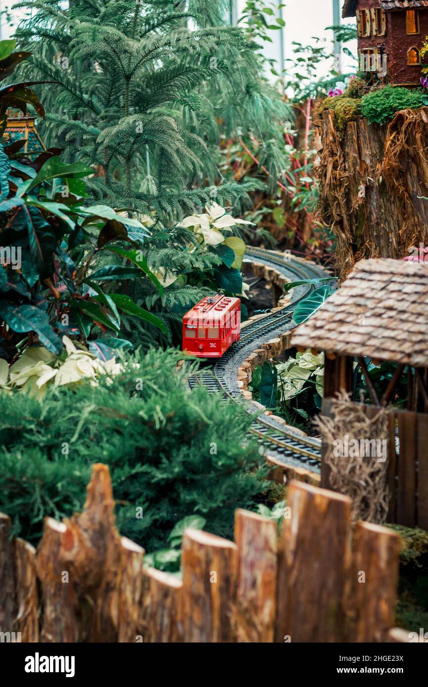 Trolley train running through a holiday train display Stock Photo - Alamy