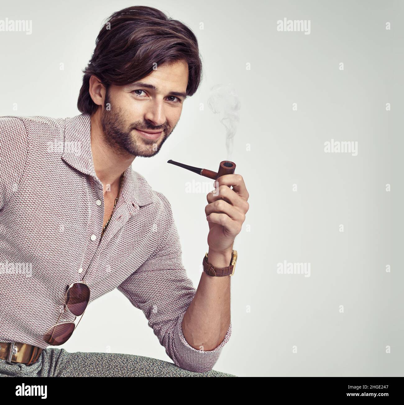 Groovy cool. A young man with 70s style sitting in the studio and ...