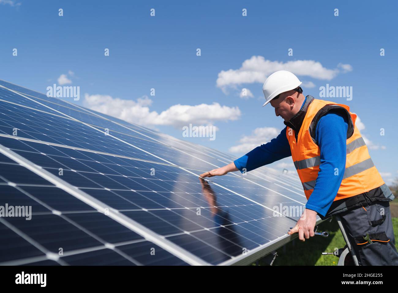 Solar power plant engineer makes a visual inspection of solar panels ...