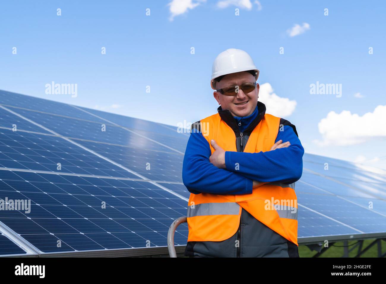 Portrait of a male electrical engineer with crossed arms against the ...