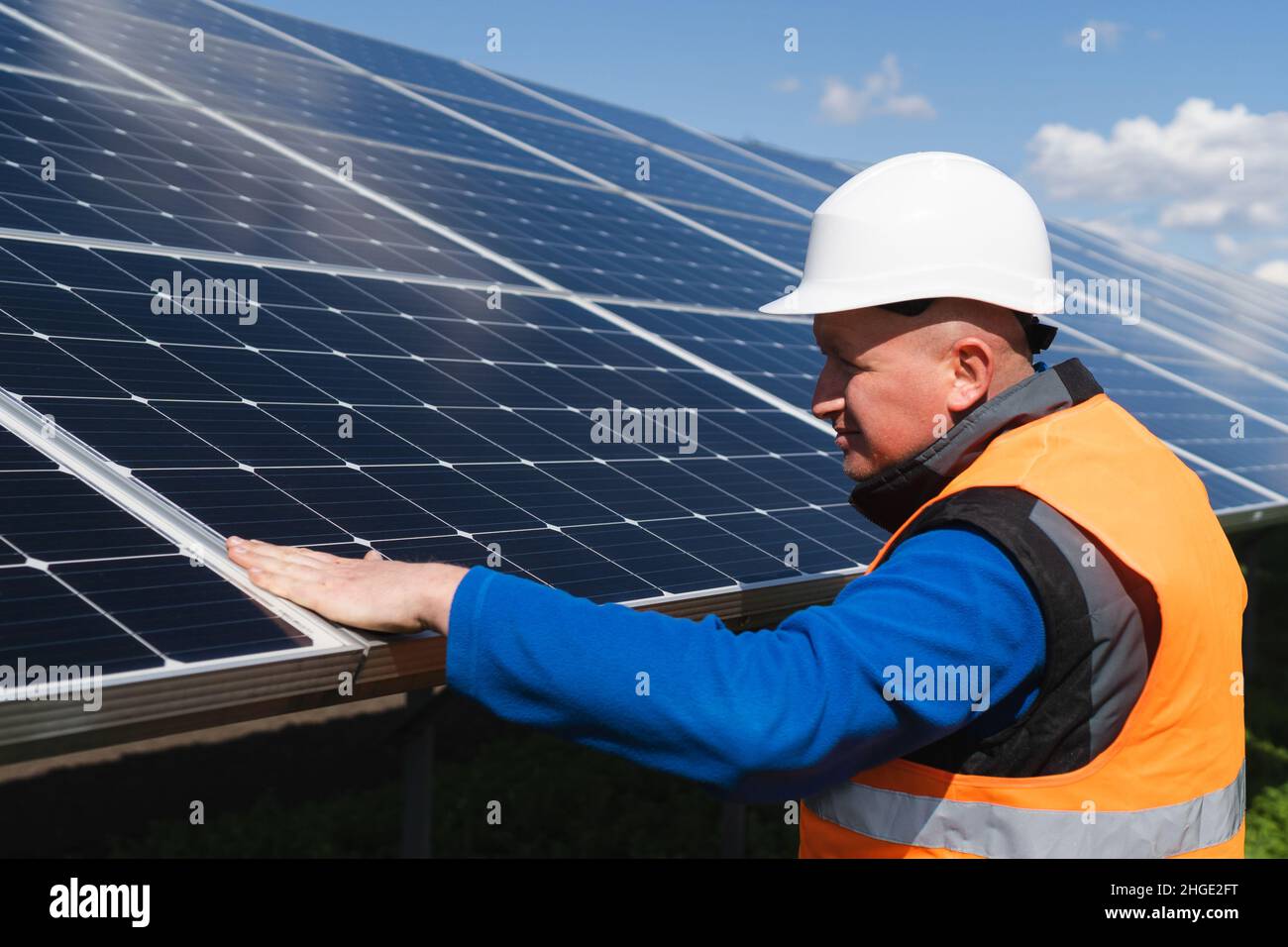 Solar plant worker inspecting photovoltaic panels for damage Stock ...