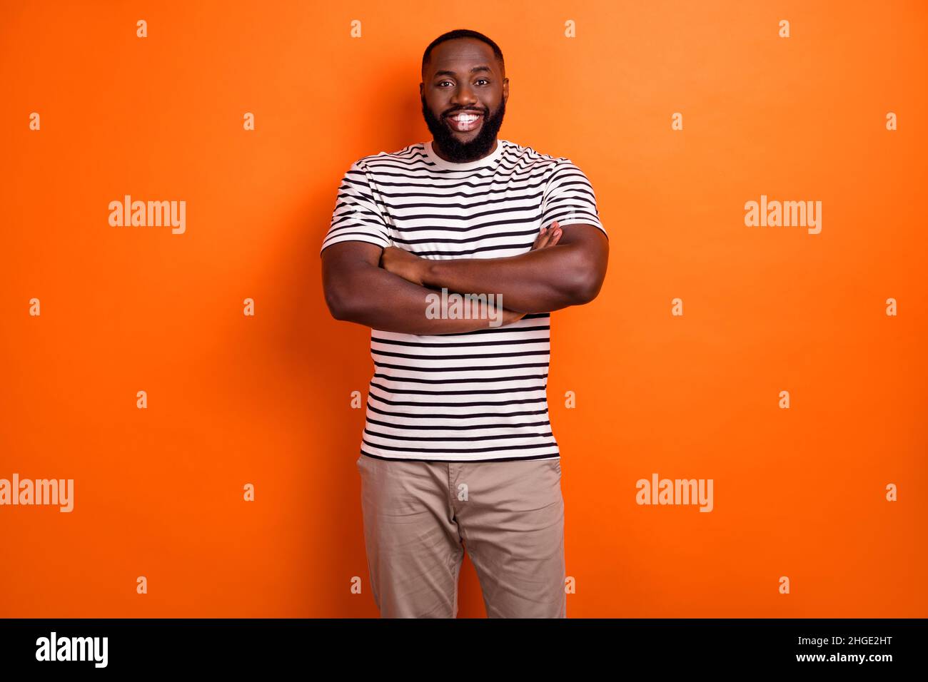 Photo of young cheerful african man crossed hands wear casual clothes ...