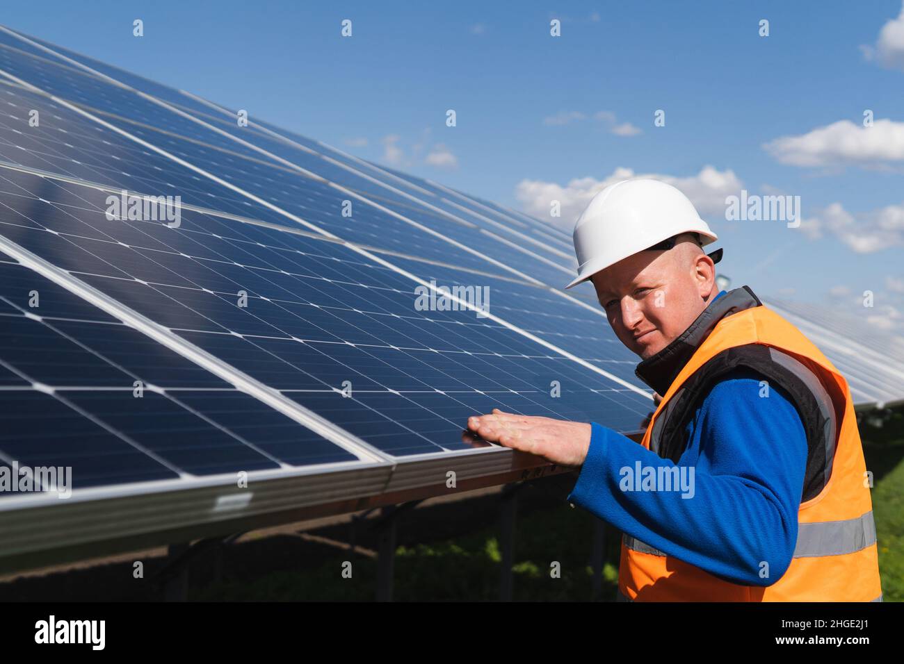 Solar plant worker inspecting photovoltaic panels for damage Stock ...