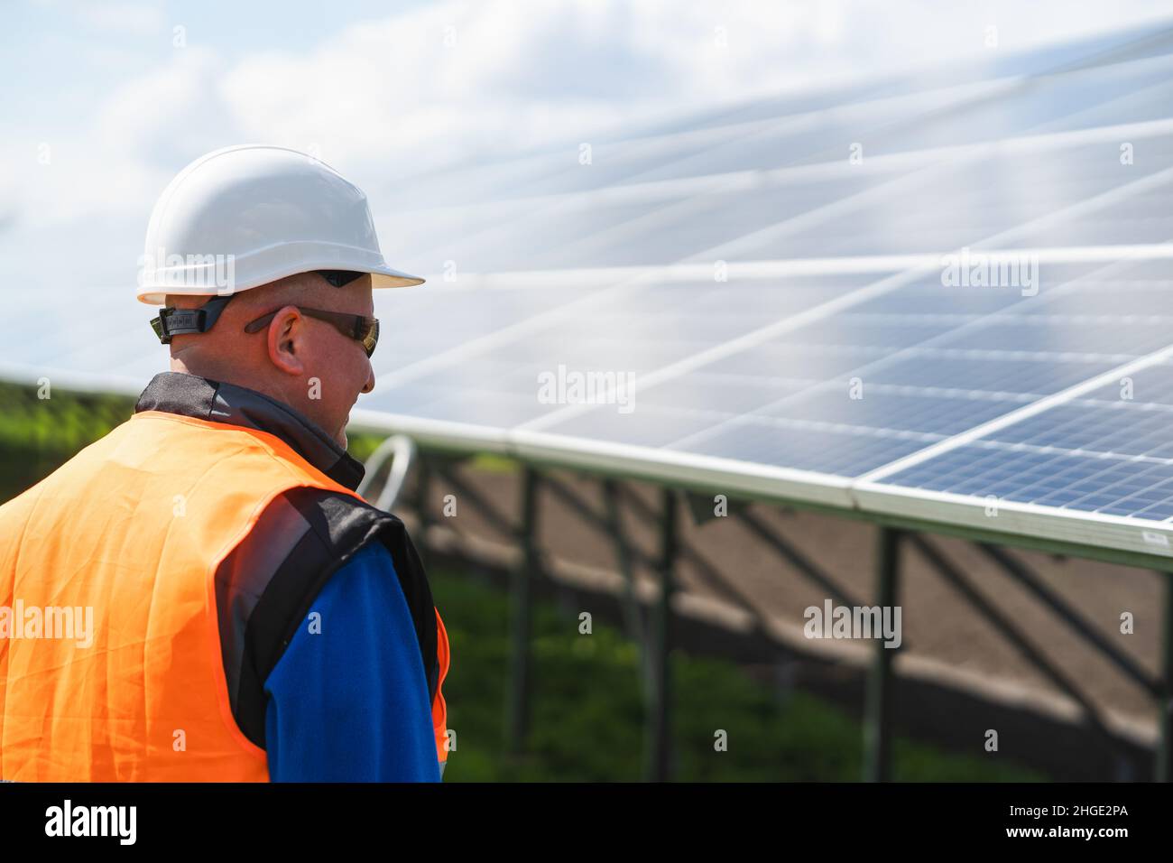 Male worker at solar panels farm Stock Photo - Alamy