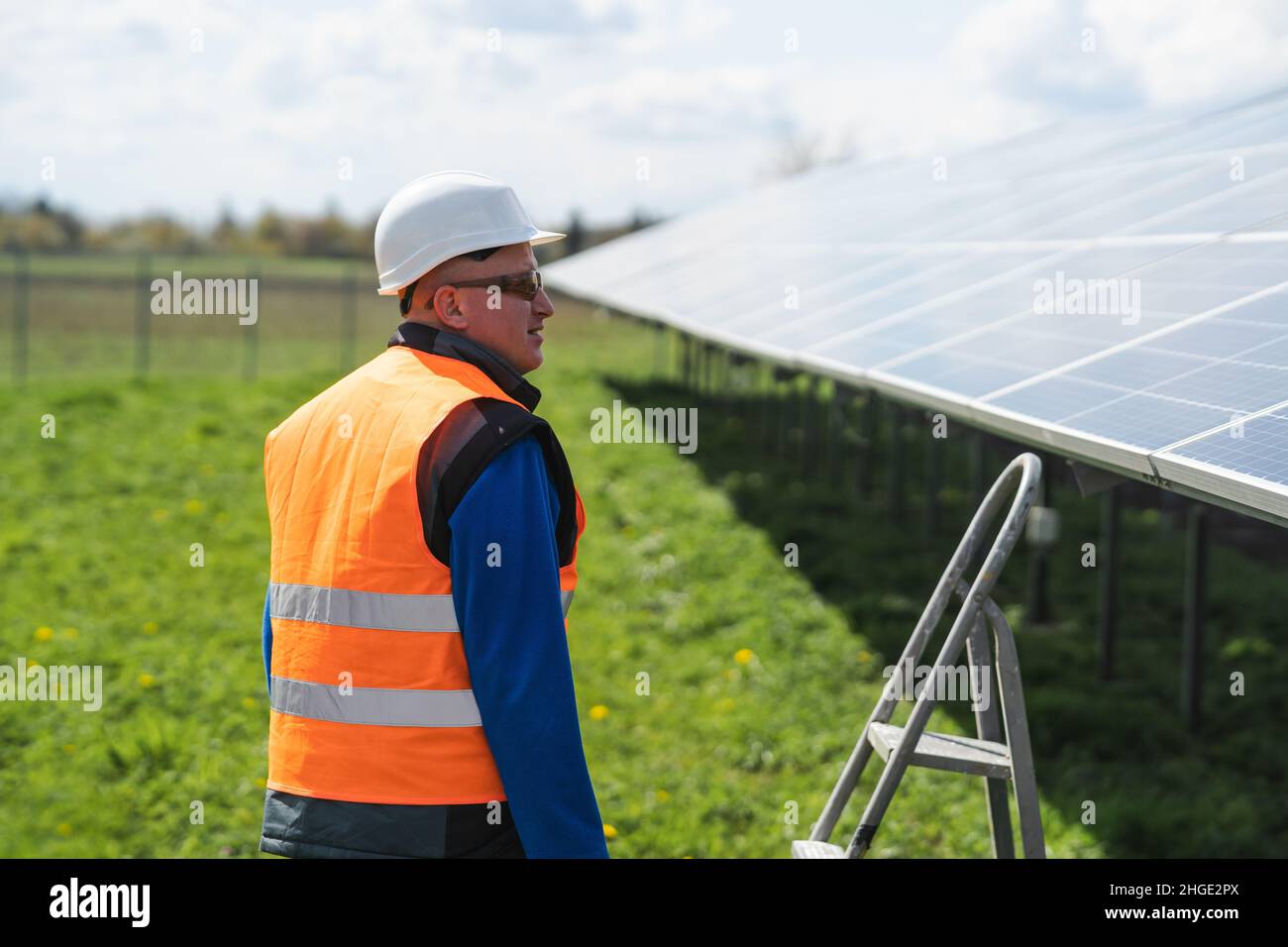 Male worker at solar panels farm Stock Photo - Alamy