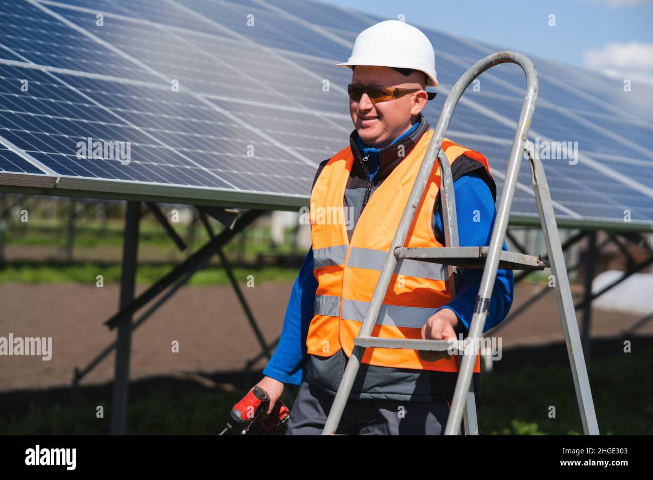 Solar Station Worker Carrying Stepladder. Solar Panel Farm Maintenance ...