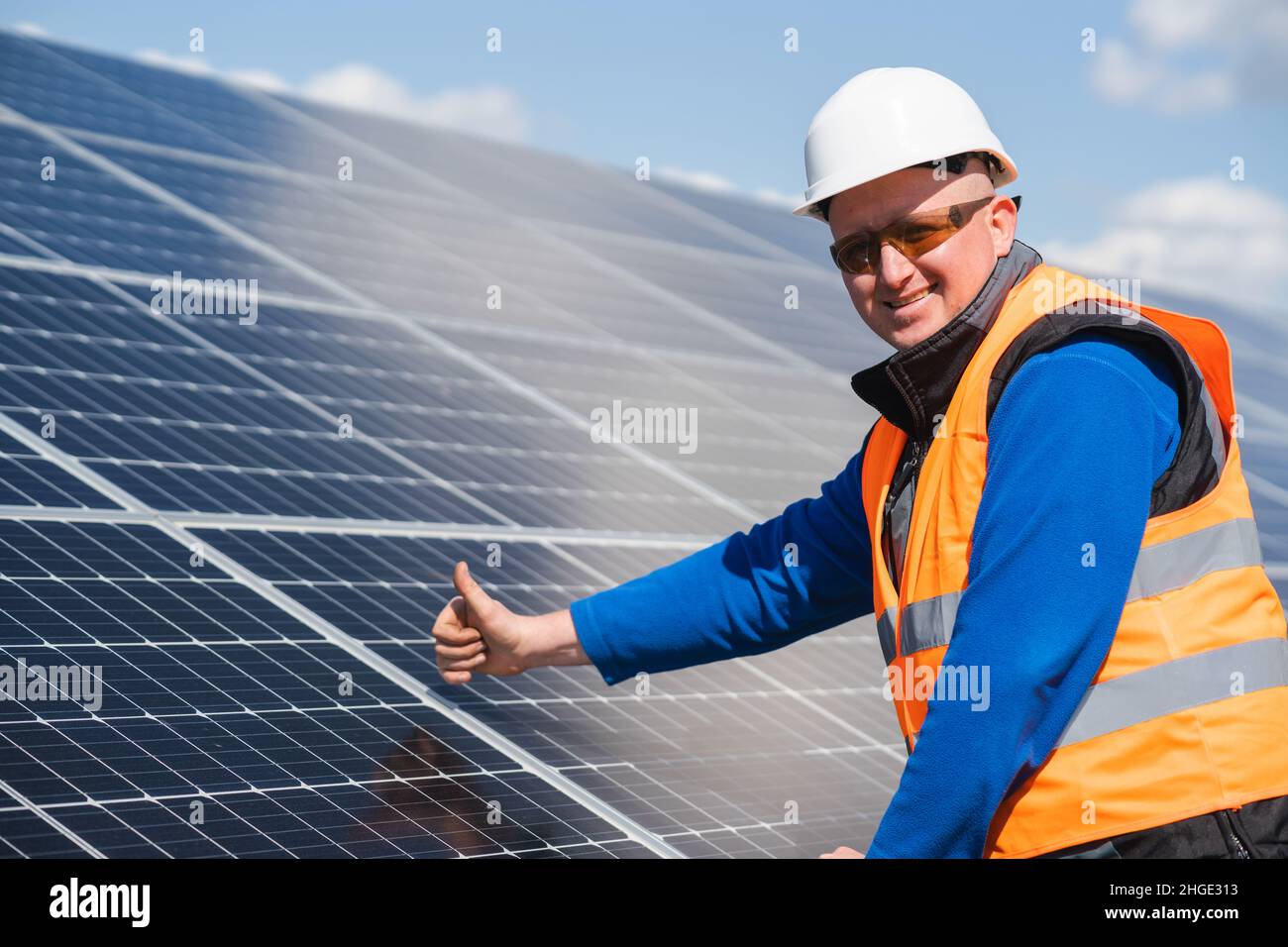 Man who works with electric solar panels shows a thumbs up Stock Photo ...