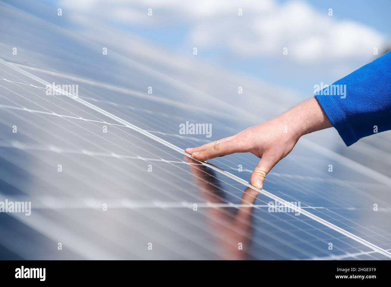 Engineer's hand on solar panel Stock Photo - Alamy