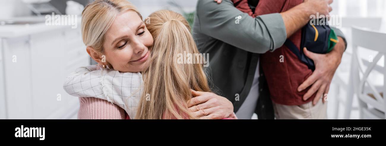 grandparents hugging schoolkids at home, banner Stock Photo - Alamy