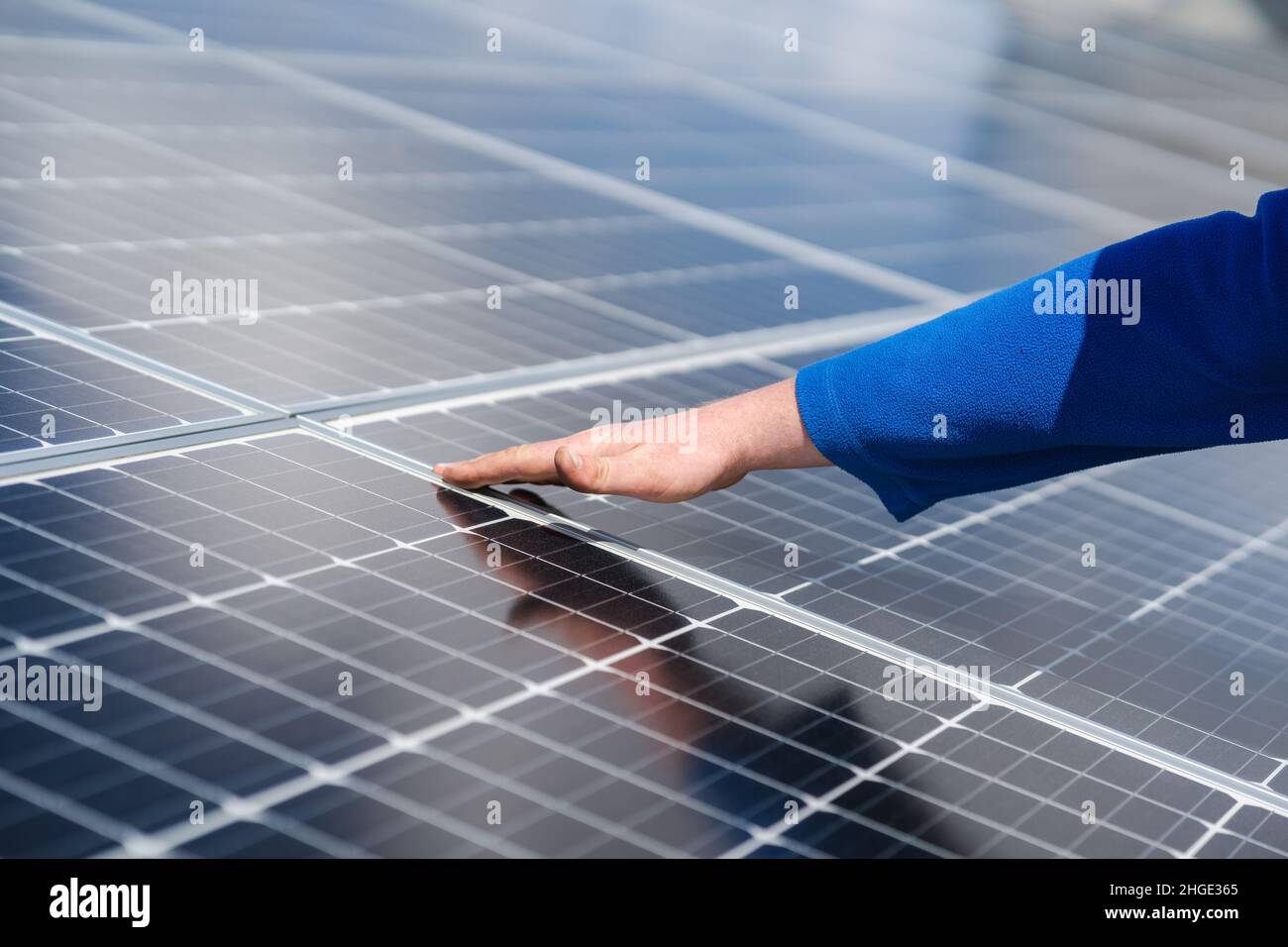 Engineer's hand on solar panel Stock Photo - Alamy