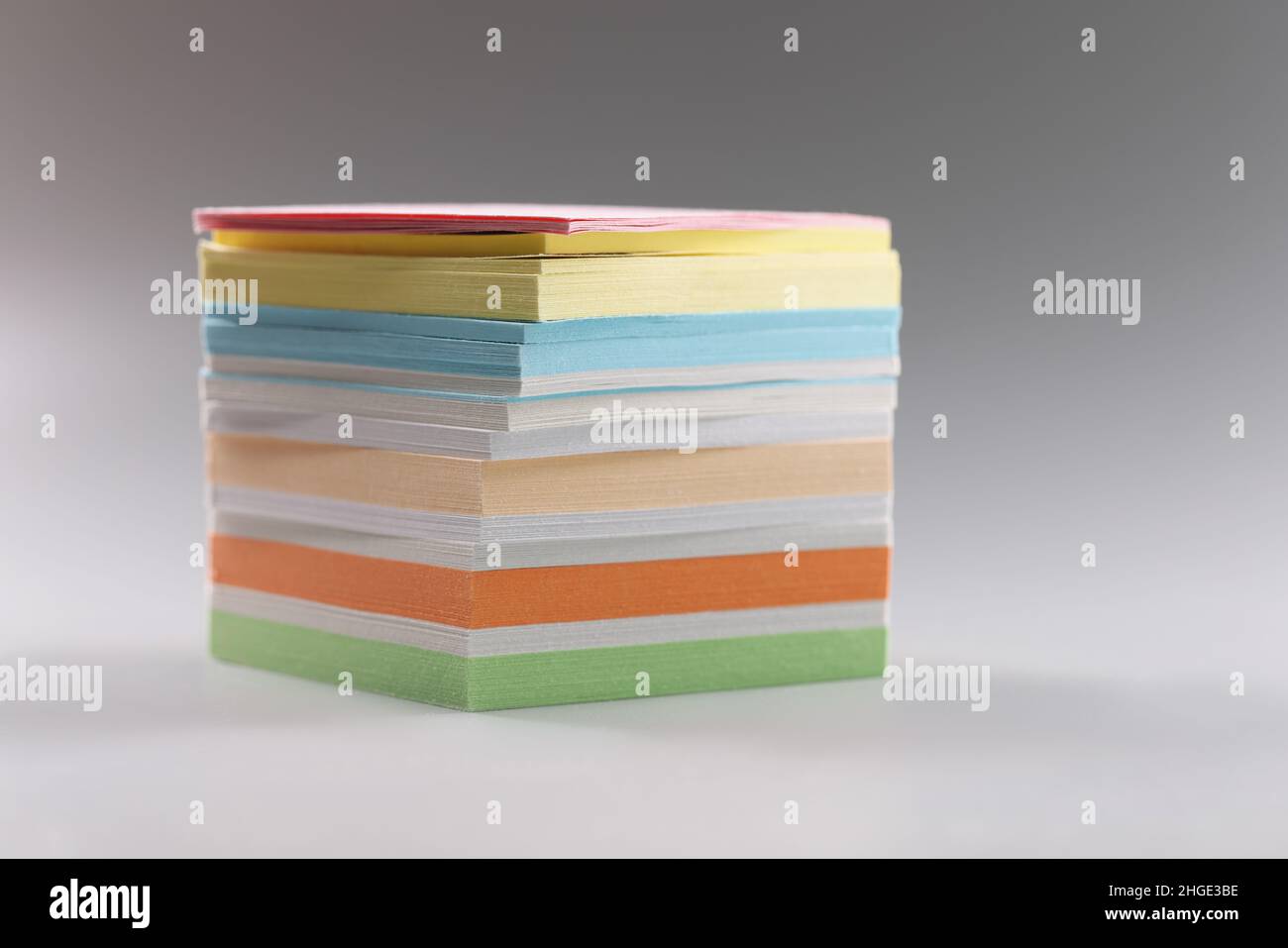 Uneven stack of sticky post it notes on grey surface, bunch of clean ...