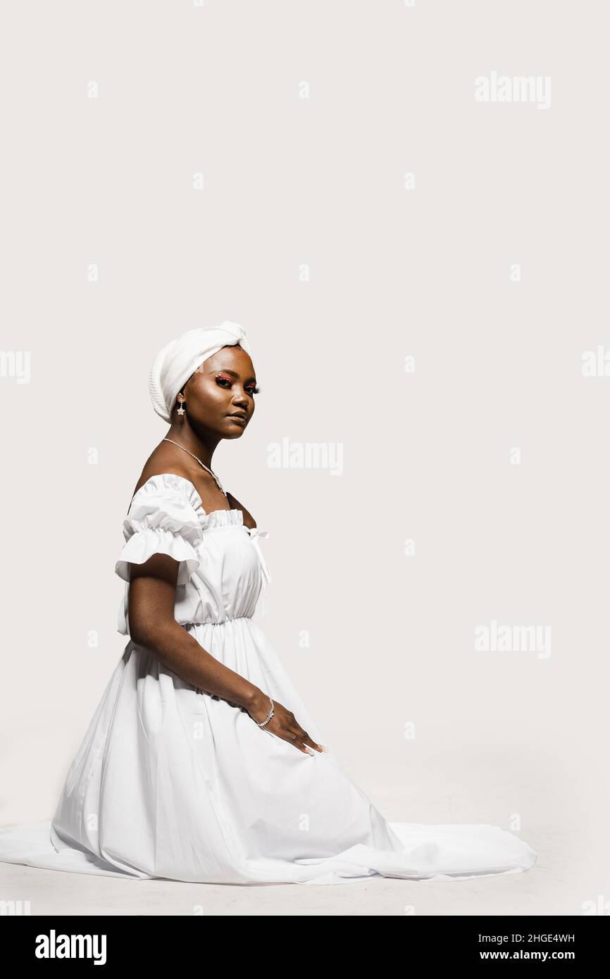 Black muslim woman is praying solat. Attractive woman in white dress ...