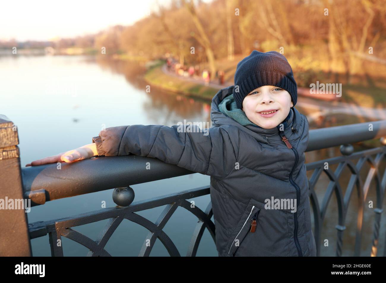Portrait of kid by lake at sunset Stock Photo - Alamy