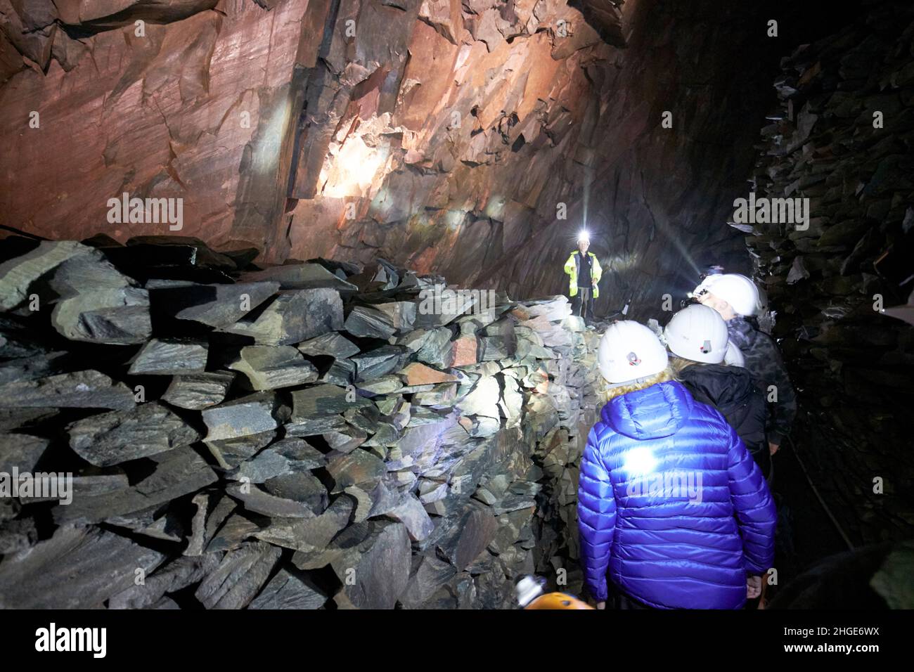 tour guide giving talk to visitors inside the honister slate mine lake ...