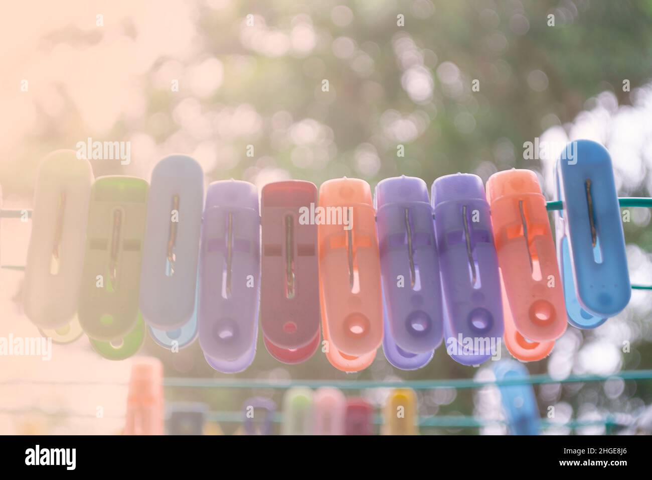 An image of very colorful clothes pegs on a clothesline Stock Photo - Alamy