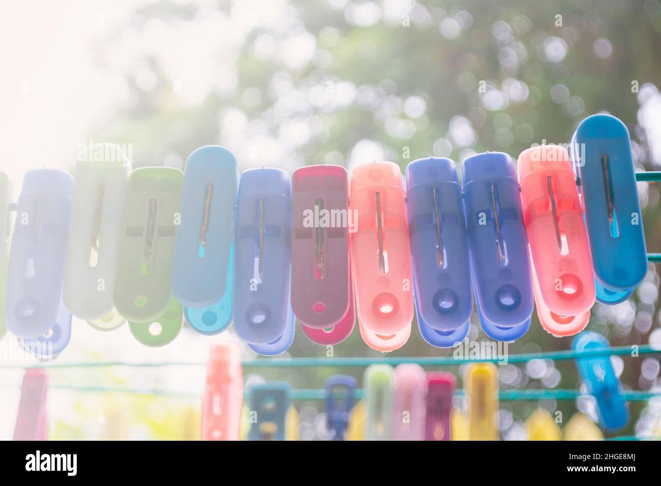 An image of very colorful clothes pegs on a clothesline Stock Photo - Alamy
