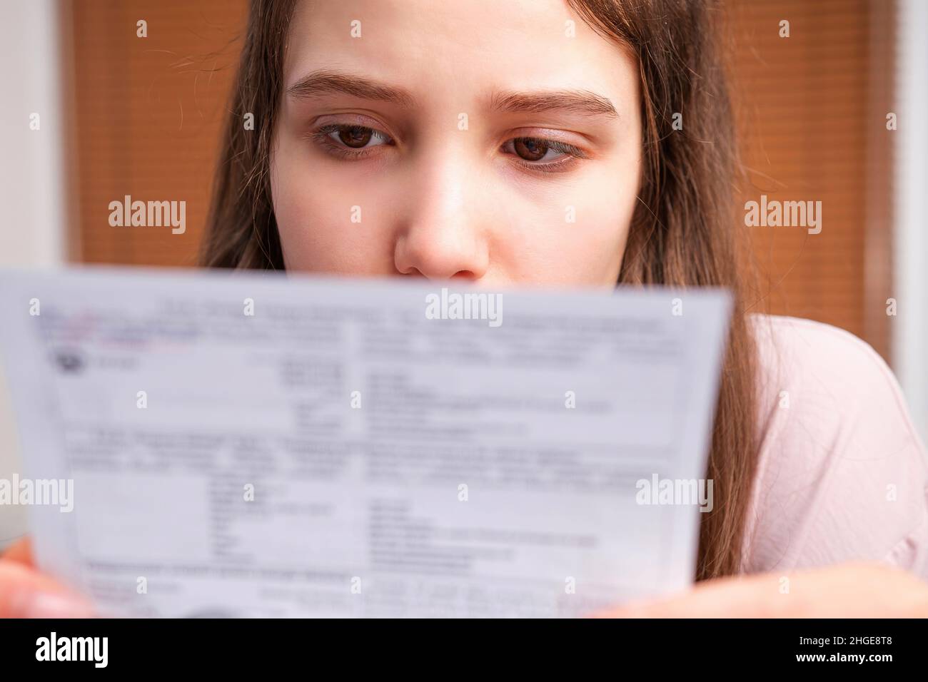 Close up photo of a young woman doing domestic accounting paperwork ...