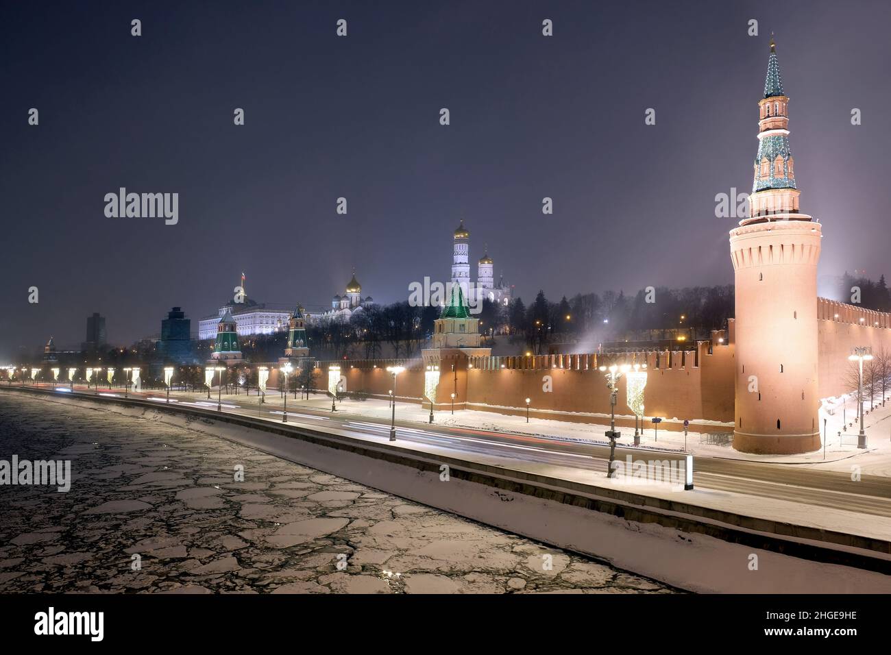 Moscow River with ice and Kremlin red brick wall with towers on ...