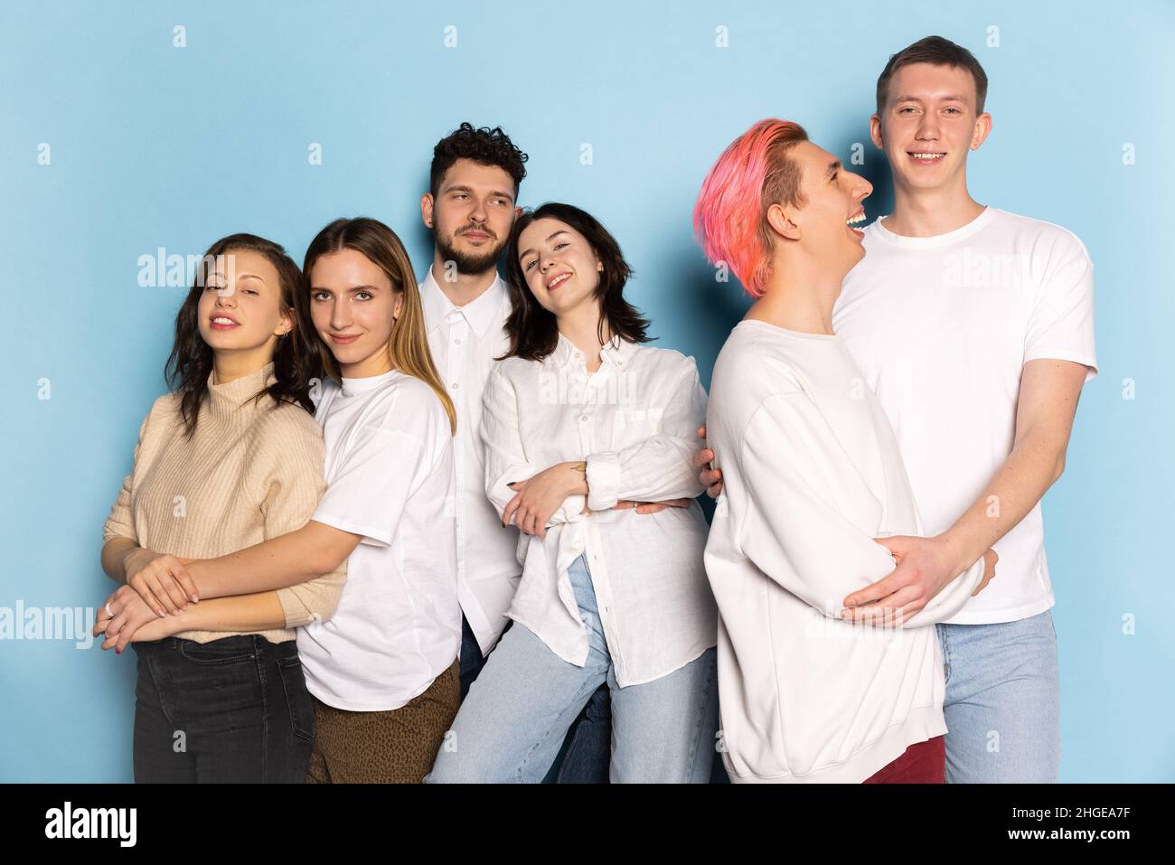 Group of young happy people, men and girls, differents couples standing ...