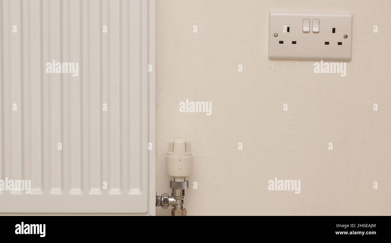 Close up of radiator and thermostat of a gas central heating system and ...