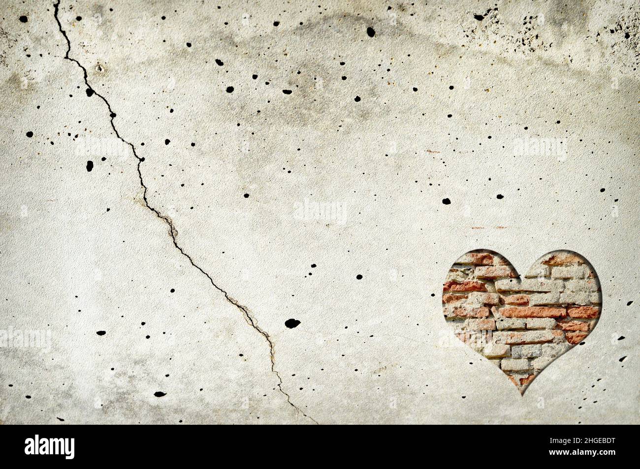 Heart shape made of old bricks on concrete wall. Valentines day ...