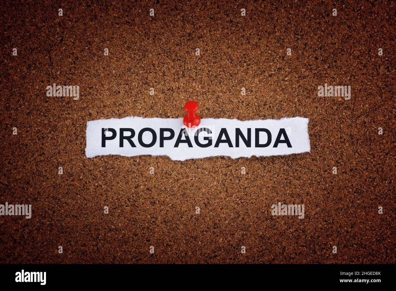A piece of paper with the word Propaganda written on it that is pinned ...