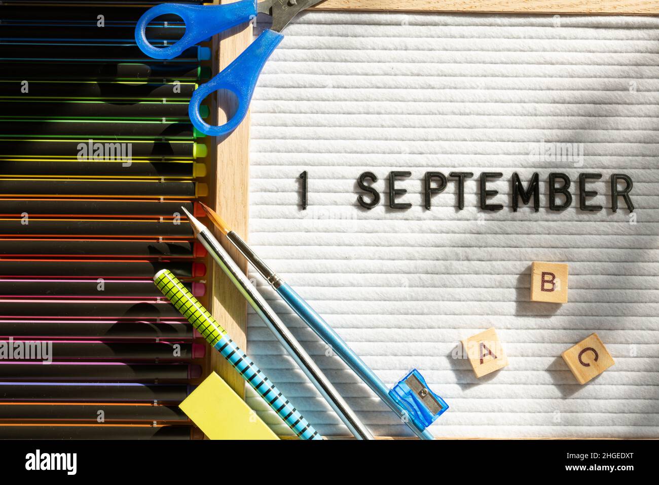 1 september letter board with school supplies as pens, scissors, ABC ...