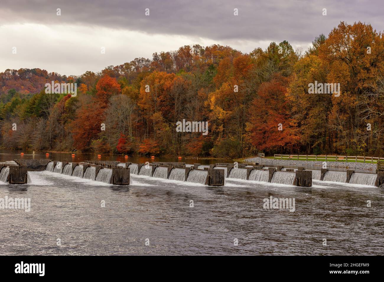Weir Dam in the foreground of an autumn landscape in the South Holston ...