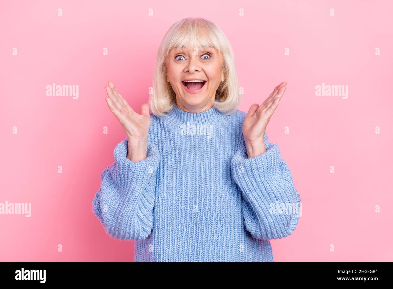 Portrait of attractive cheerful lucky grey-haired woman applauding ...