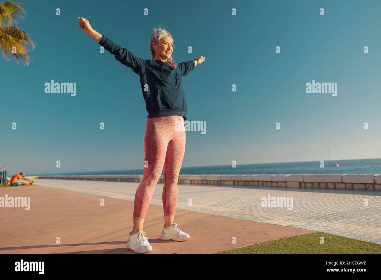 Active joyful adult woman is exercising outdoors Stock Photo - Alamy