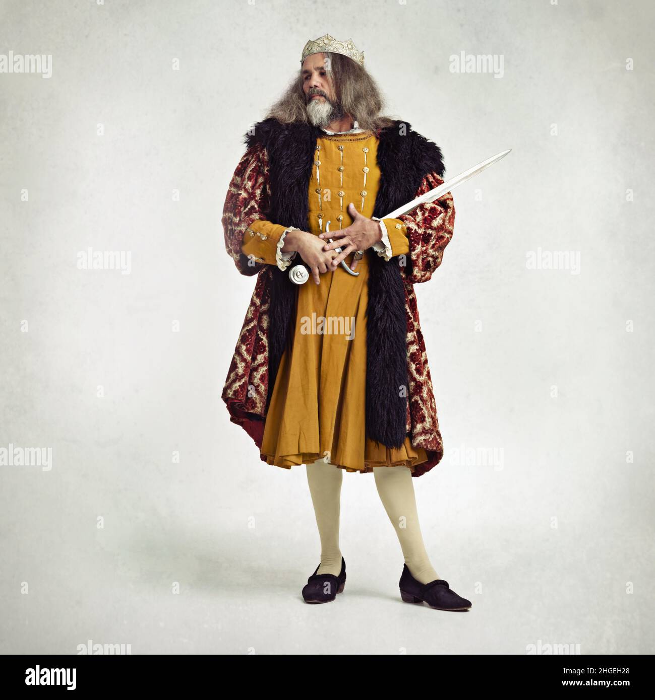 Wielding the sword of kings. Studio shot of a richly garbed king ...