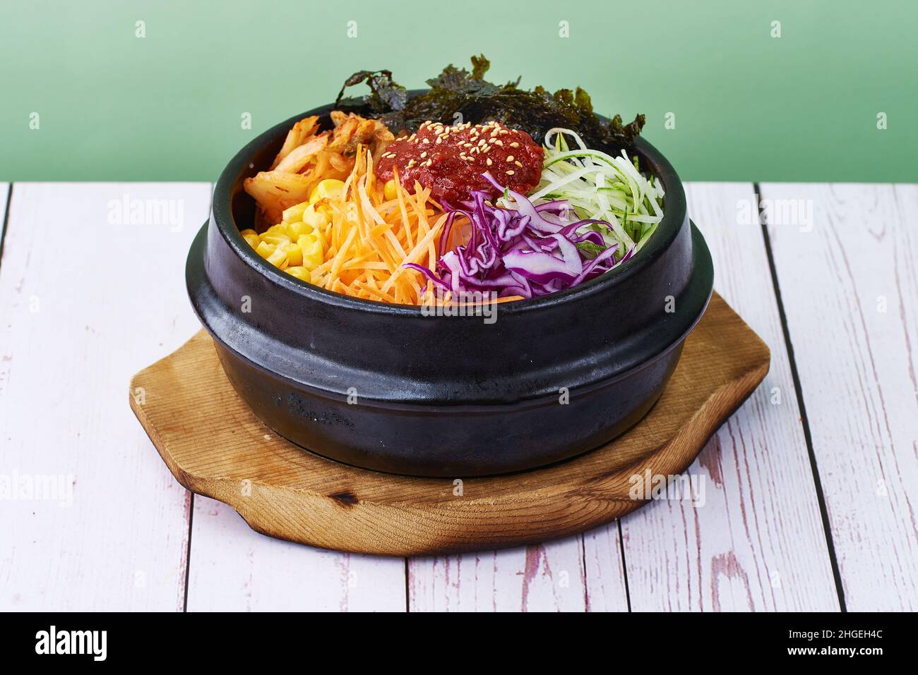 Korean food rice bibimbap with vegetables, beef and teriyaki in a black ...