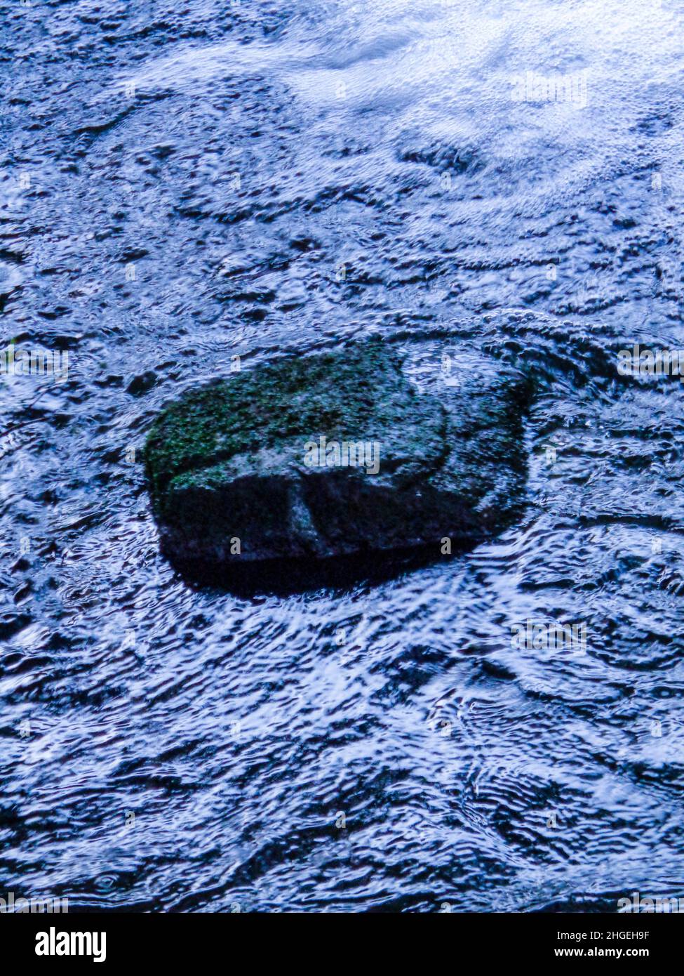 Close-up semi-abstract intimate still life of water swirling about a ...