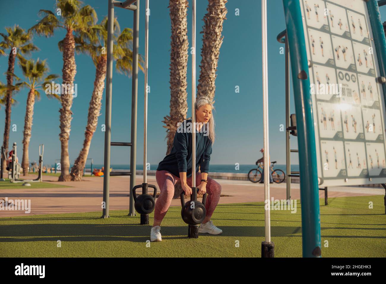 Strong lady actively exercising by the waterfront Stock Photo - Alamy