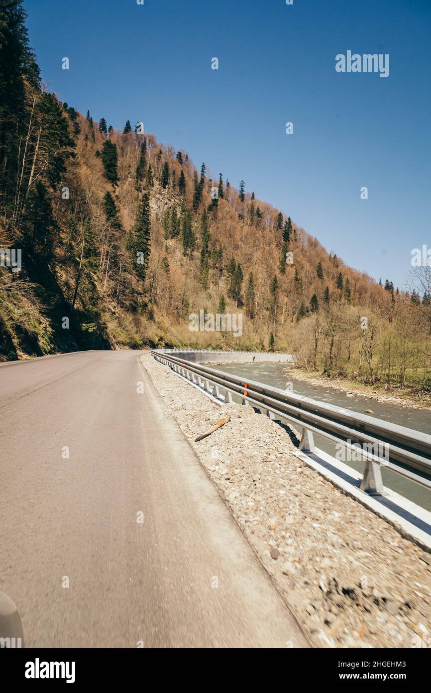 Mountain road trouble river, mixed forest fortification shore Stock ...