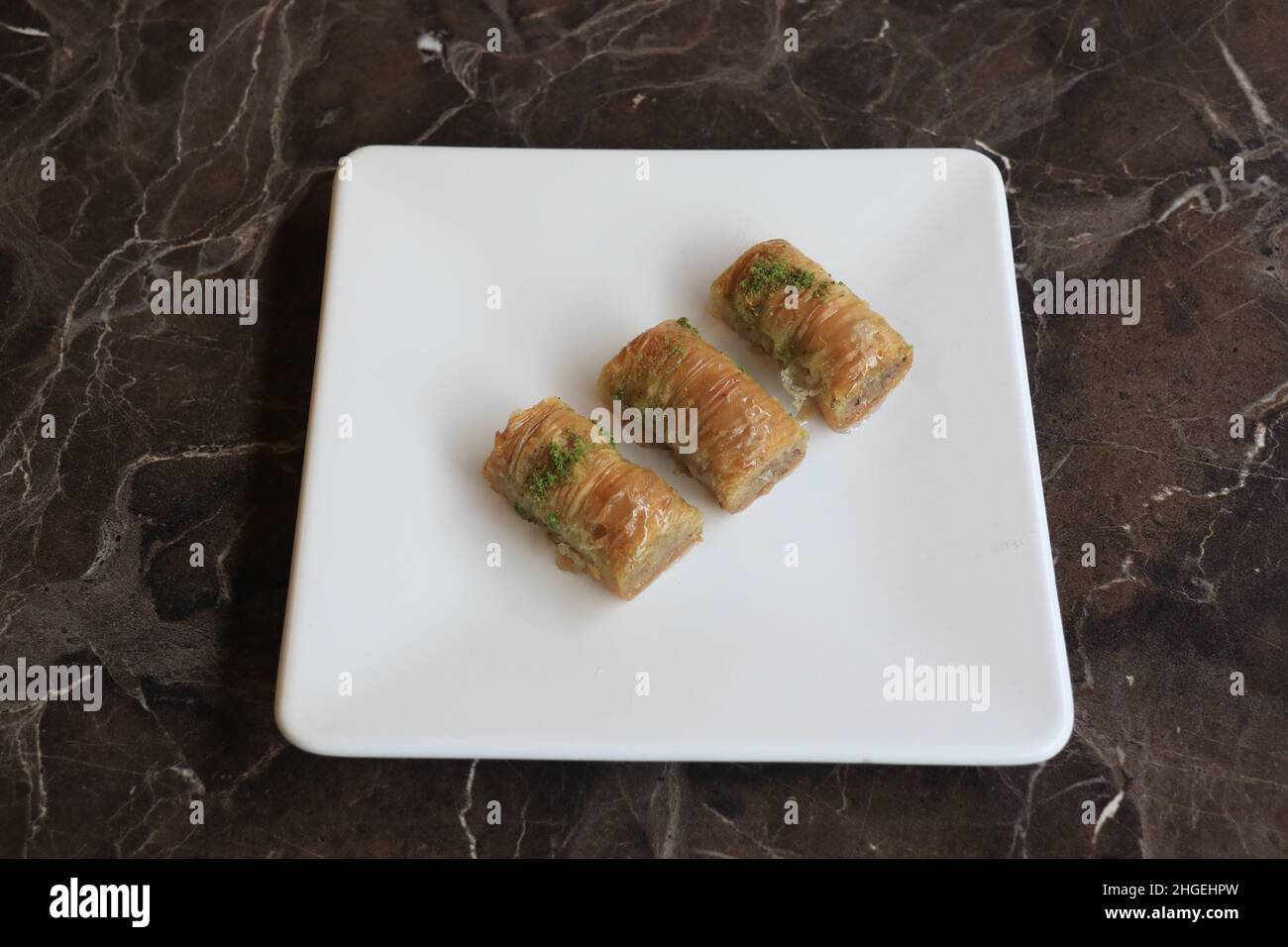 Baklava is a layered pastry dessert made of filo pastry, filled with ...