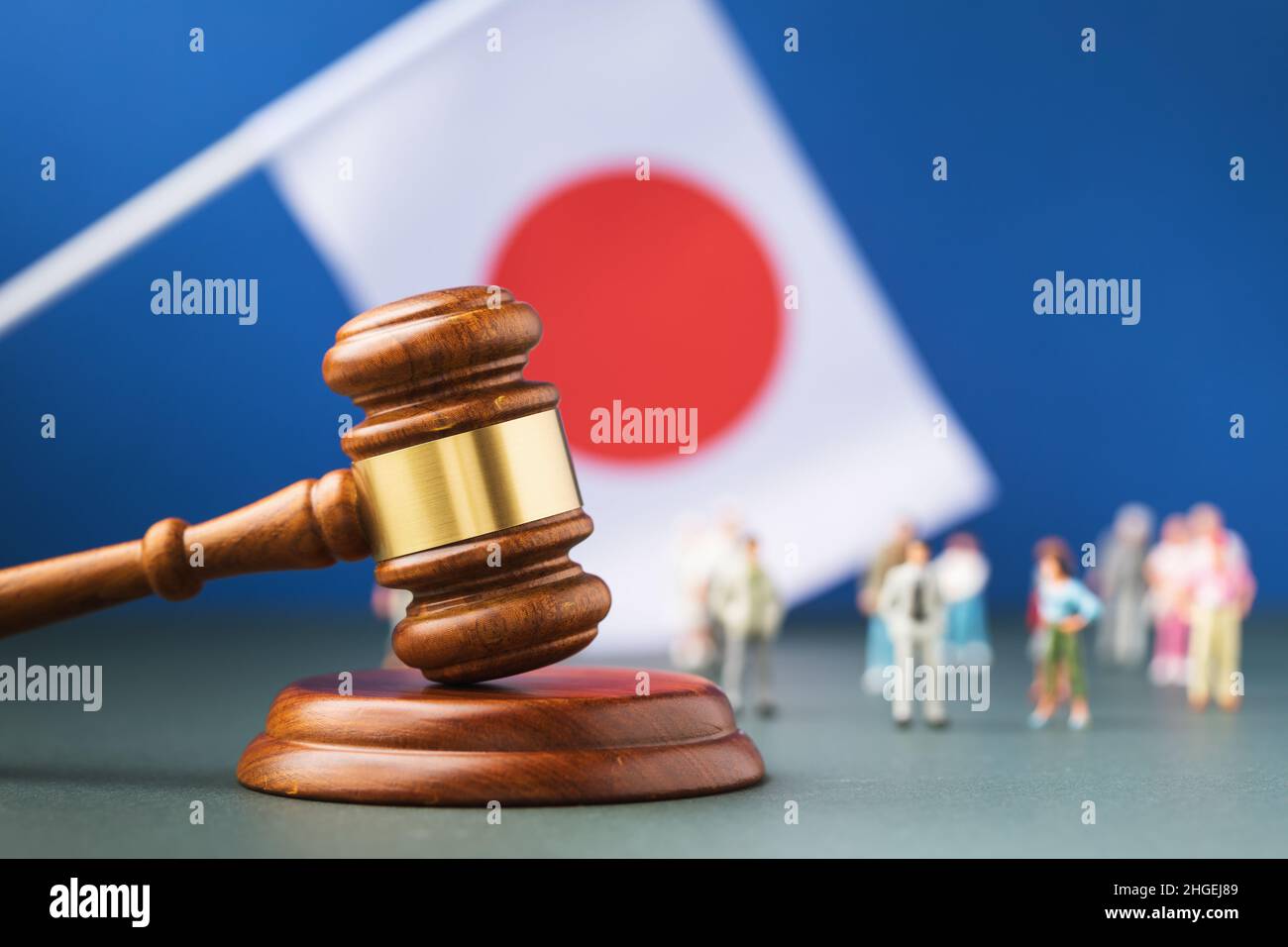 Judge gavel, Japanese flag and plastic toy men on a colored background ...
