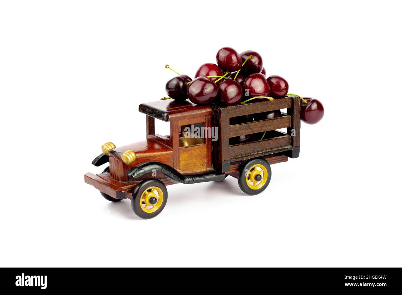 Ripe sweet cherries in a wooden toy truck on white background Stock ...