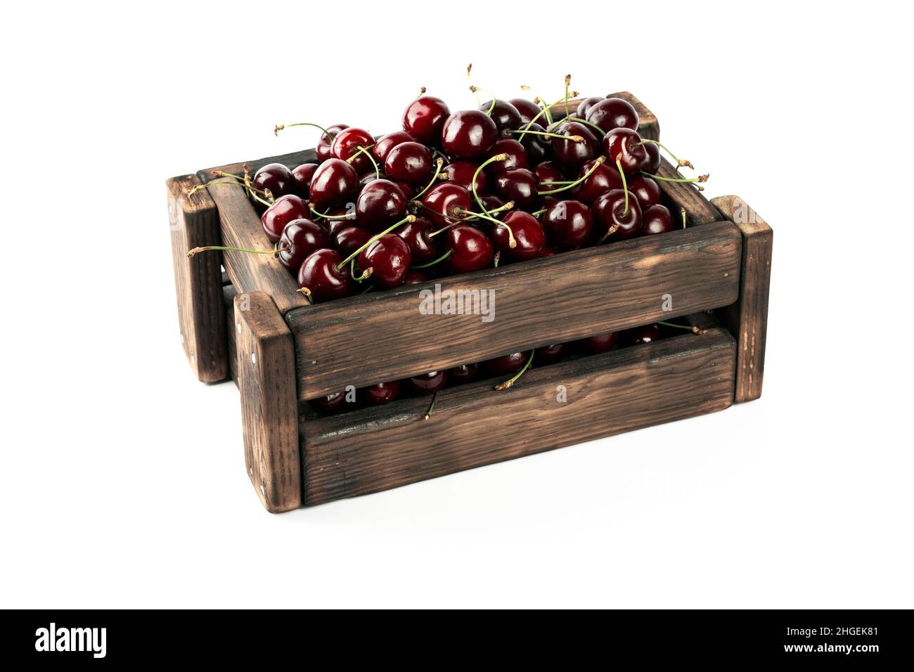 Cherry in box. Sweet fresh cherry in wooden brown box on white ...