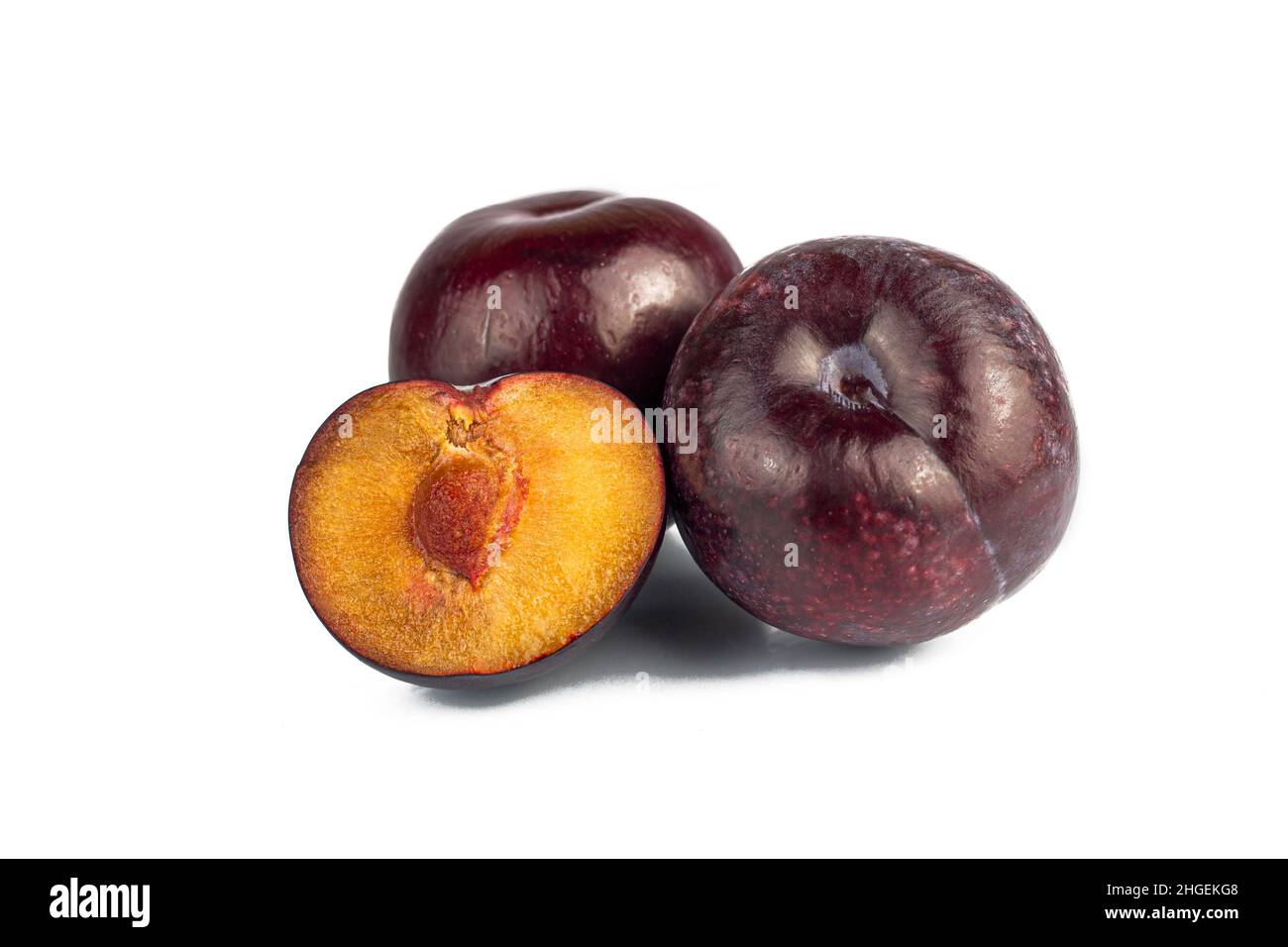 Whole and half ripe plums isolated on white background. Natural and ...
