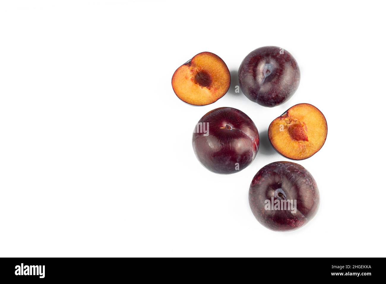 Whole and half ripe plums isolated on white background. Natural and ...