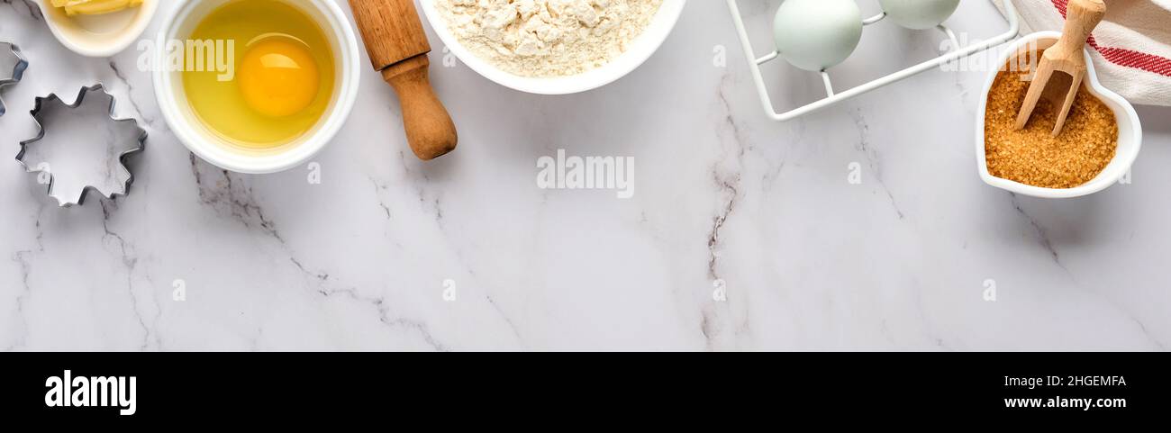 Baking background with flour, eggs, kitchen tools, utensils and cookie ...
