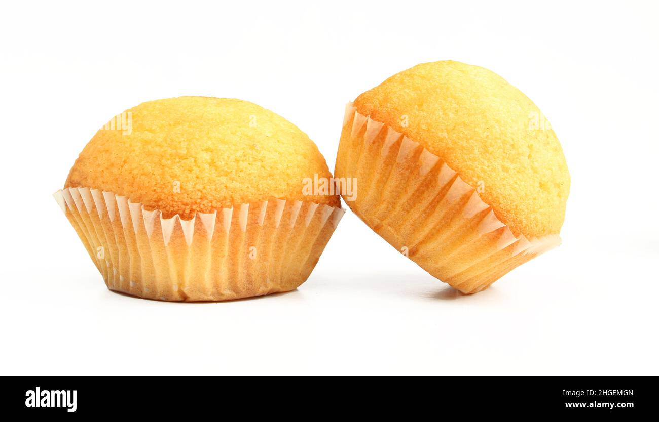 Two yellow muffin sweets isolated on white background Stock Photo - Alamy