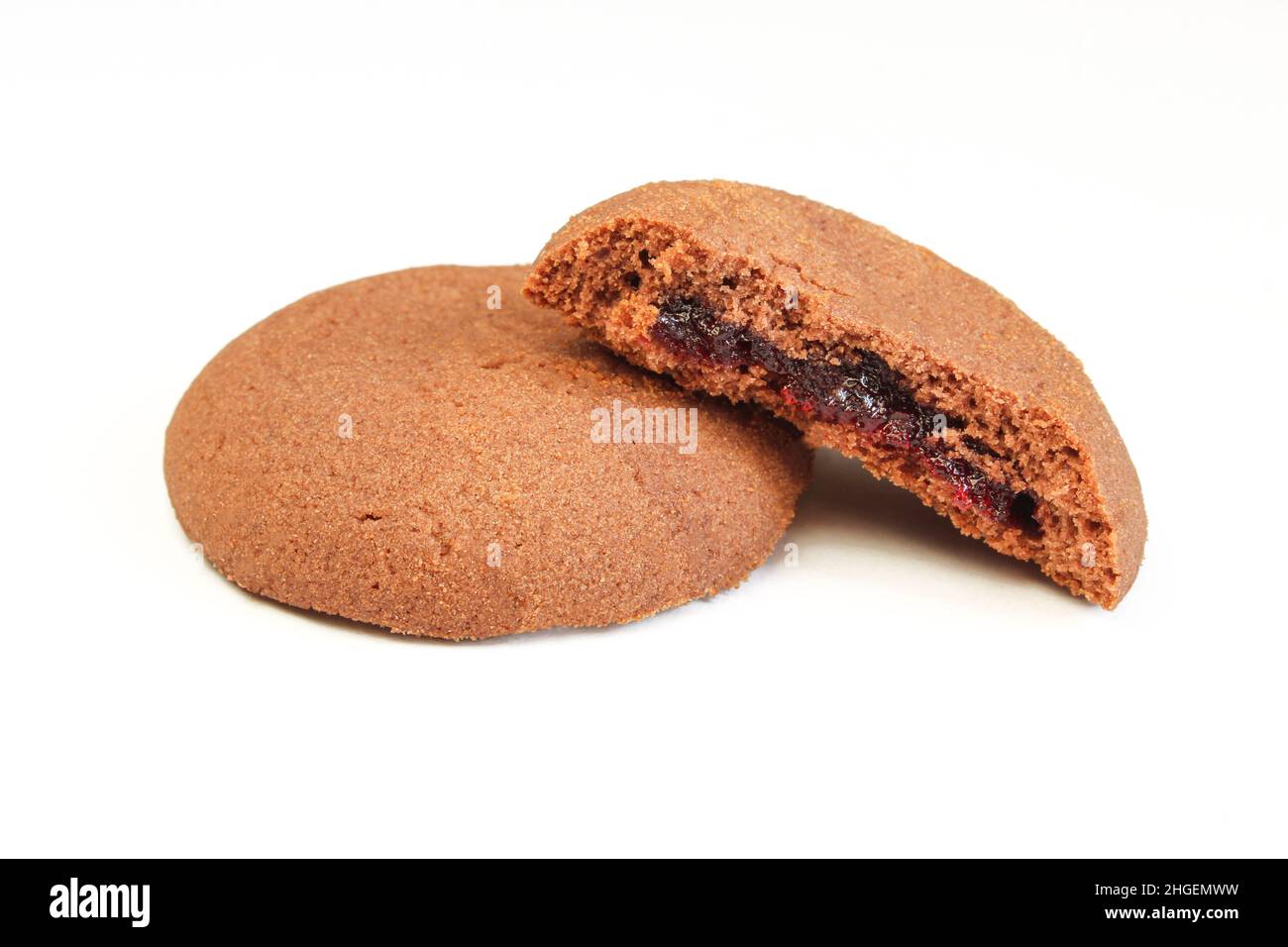 Brown tea biscuits with cherry filling isolated on white background ...