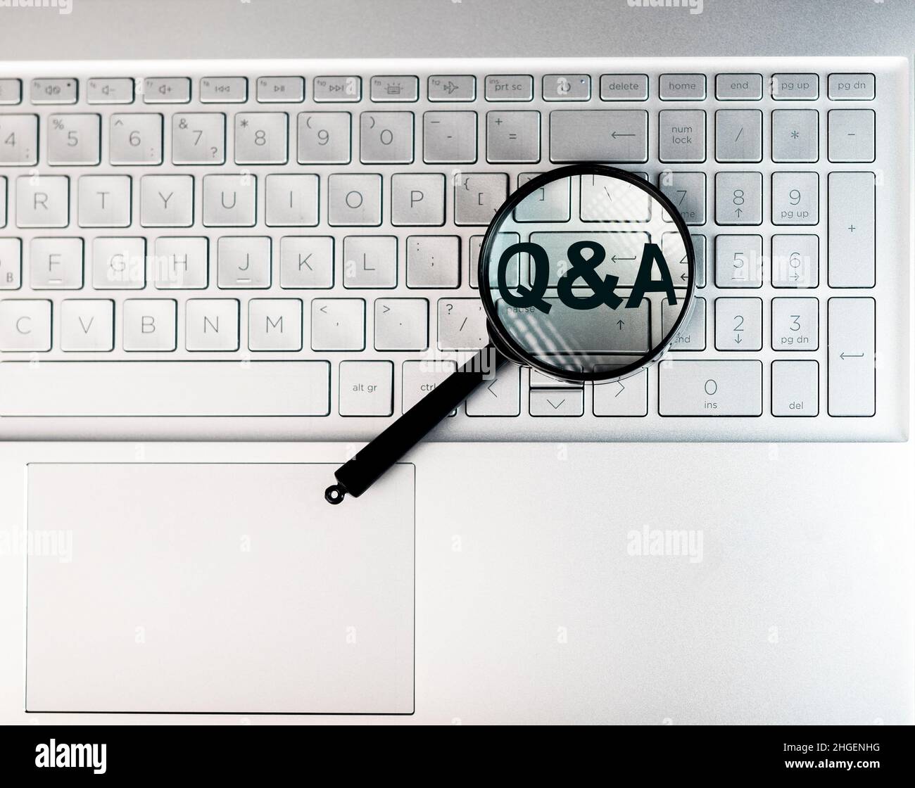 Q and A concept. QnA through magnifying glass Stock Photo - Alamy